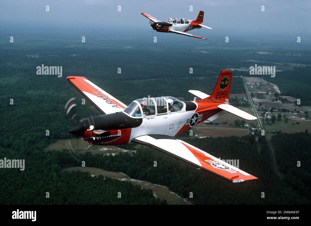 An air-to-air left front view of two T-34C Mentor aircraft flying in ...