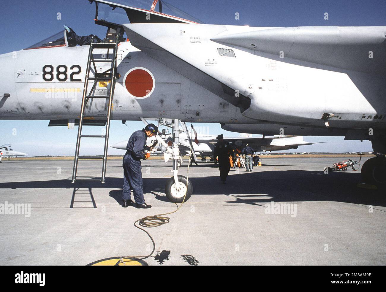 A Japanese Air Self Defense Force flight crewman conducts a preflight ...