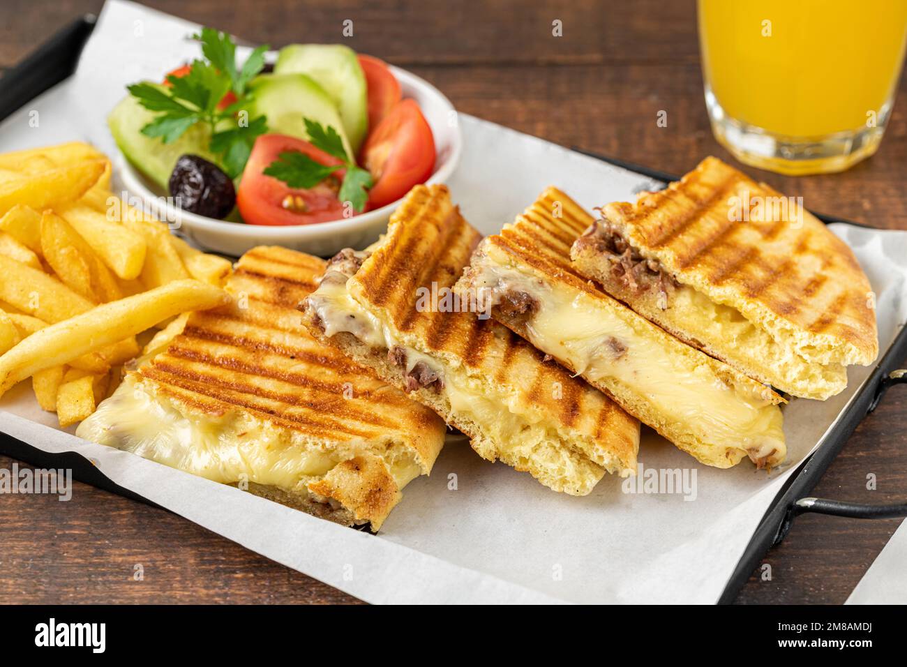 Turkish toast with roasted meat served with olives, cucumbers and ...