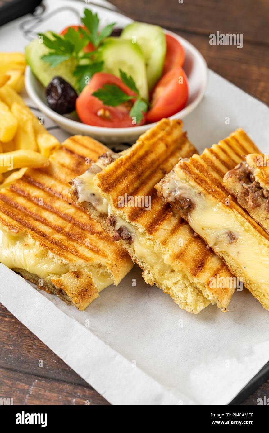 Turkish toast with roasted meat served with olives, cucumbers and ...