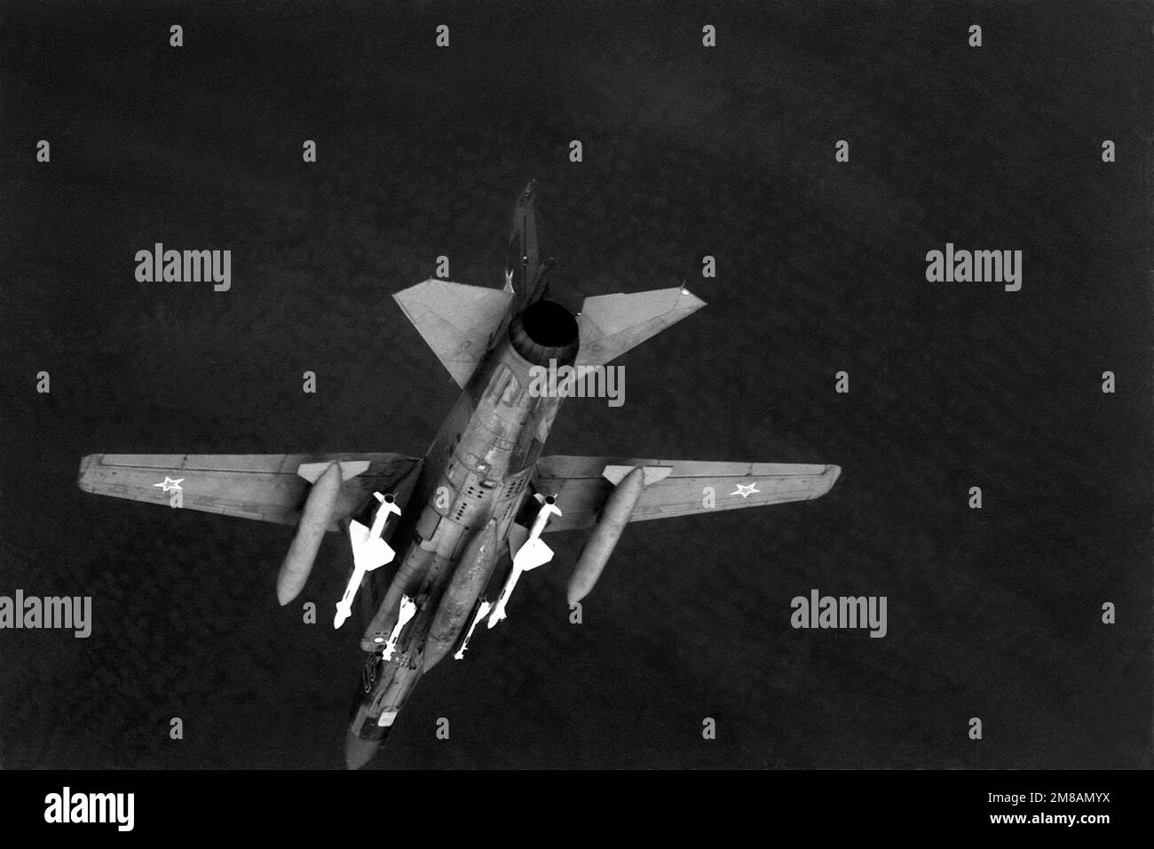 An air-to-air underside view of a Soviet MiG-23 Flogger aircraft. The ...