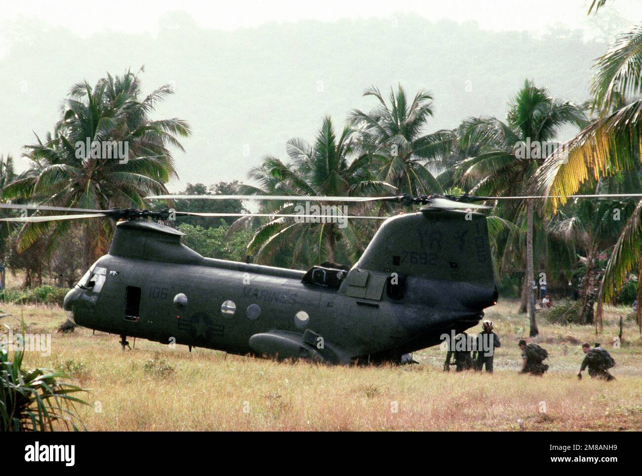 A Marine Corps CH-46E Sea Knight helicopter lands to pick up troops ...