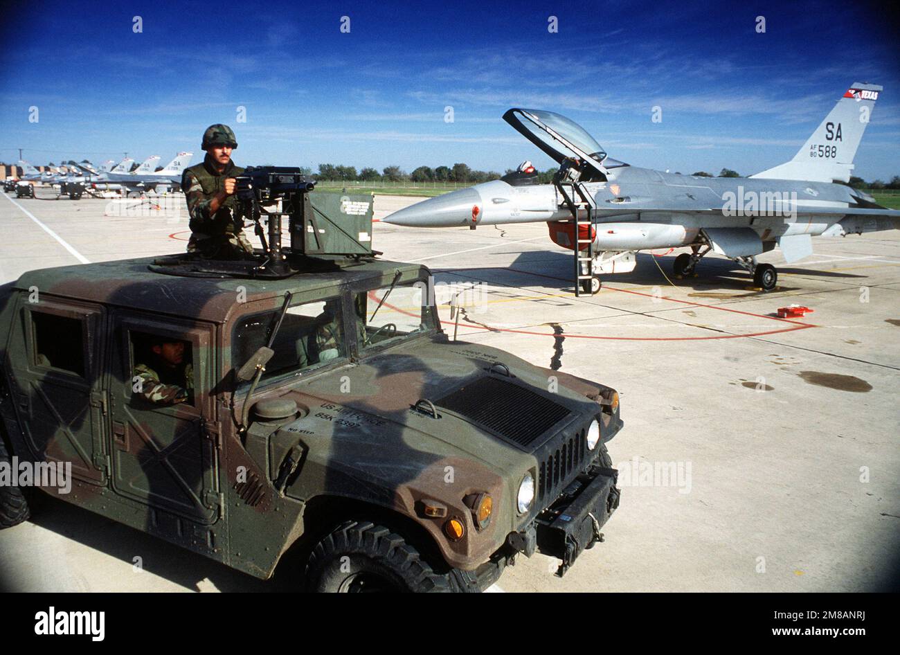 Security policeman mans a Browning M-2, 50 Cal machine gun mounted on a ...
