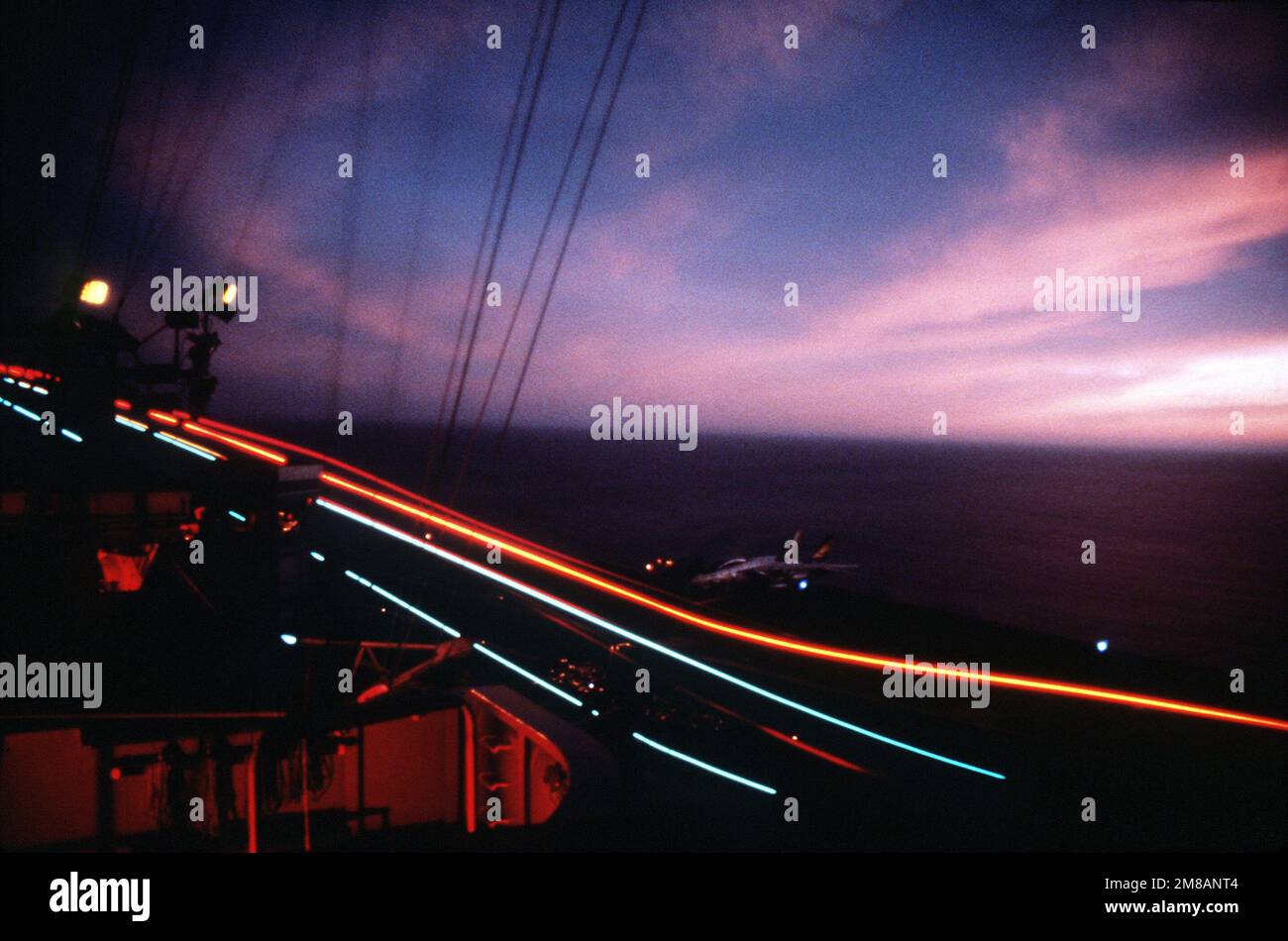 Running lights mark the path of an aircraft landing at night on the ...