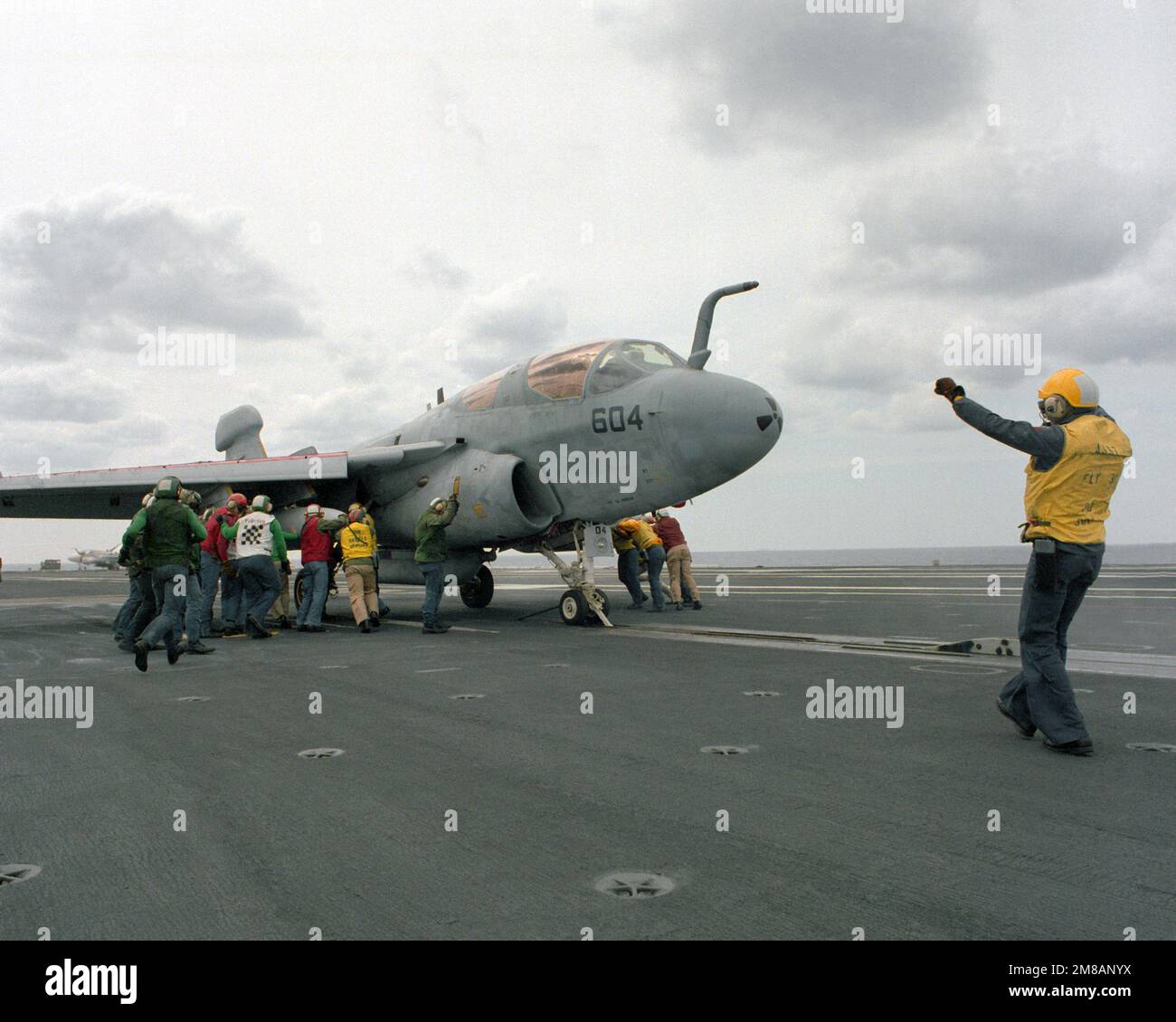 Flight deck crew members eady a Tactical Electronic Warfare Squadron ...