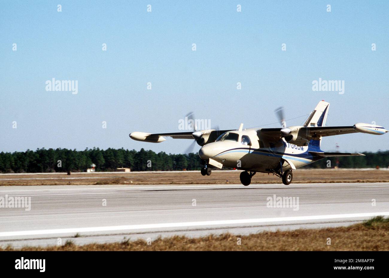 A Mitsubishi MU-2 aircraft lifts off at the end of its takeoff roll ...