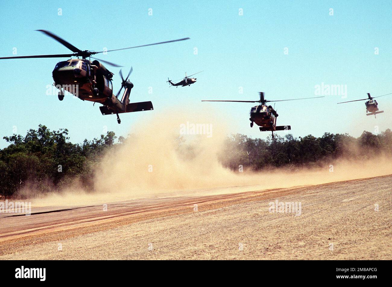 Four Australian Army UH-60 Black Hawk helicopters come in to land ...