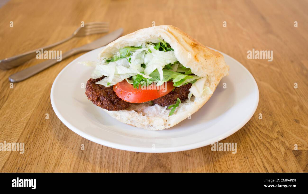 Falafel combo dish with vegetables. Faláfel or falafel is a chickpea or ...