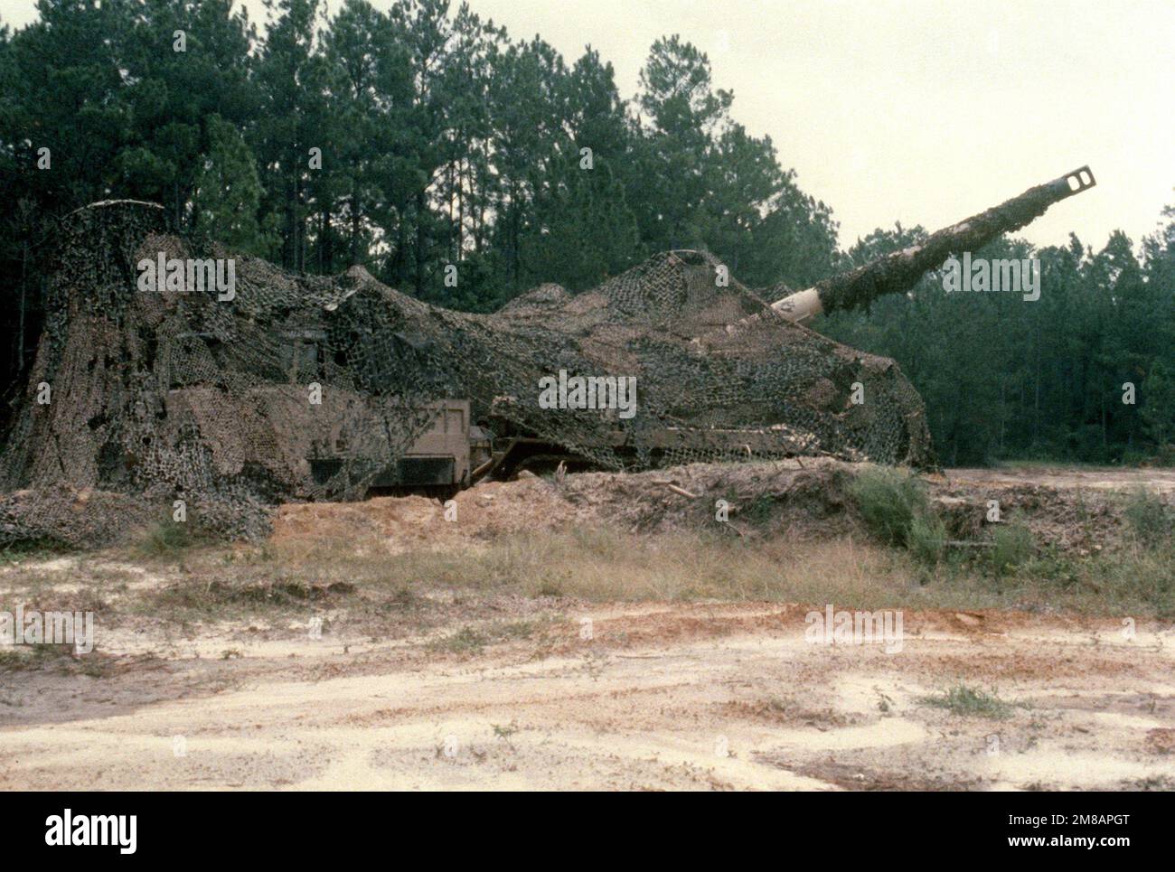 A view of an M-548 tracked cargo carrier, left, and an M-110A2 8-inch ...