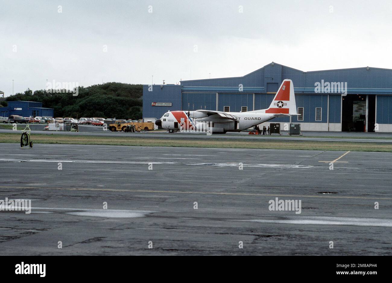 A Coast Guard C-130 Hercules aircraft is serviced on the flight line ...