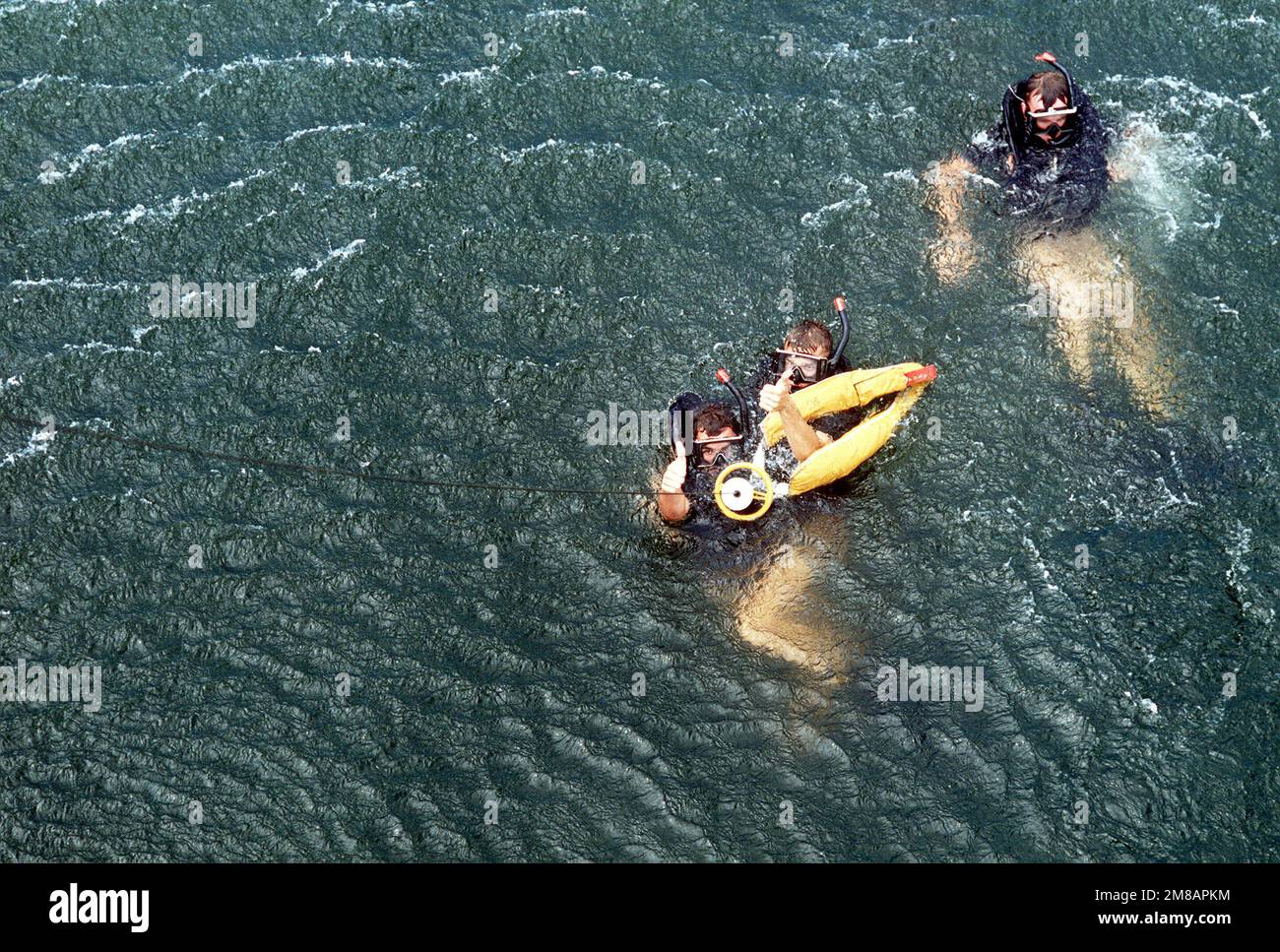 Two search and rescue (SAR) swimmers signal that all is well before ...