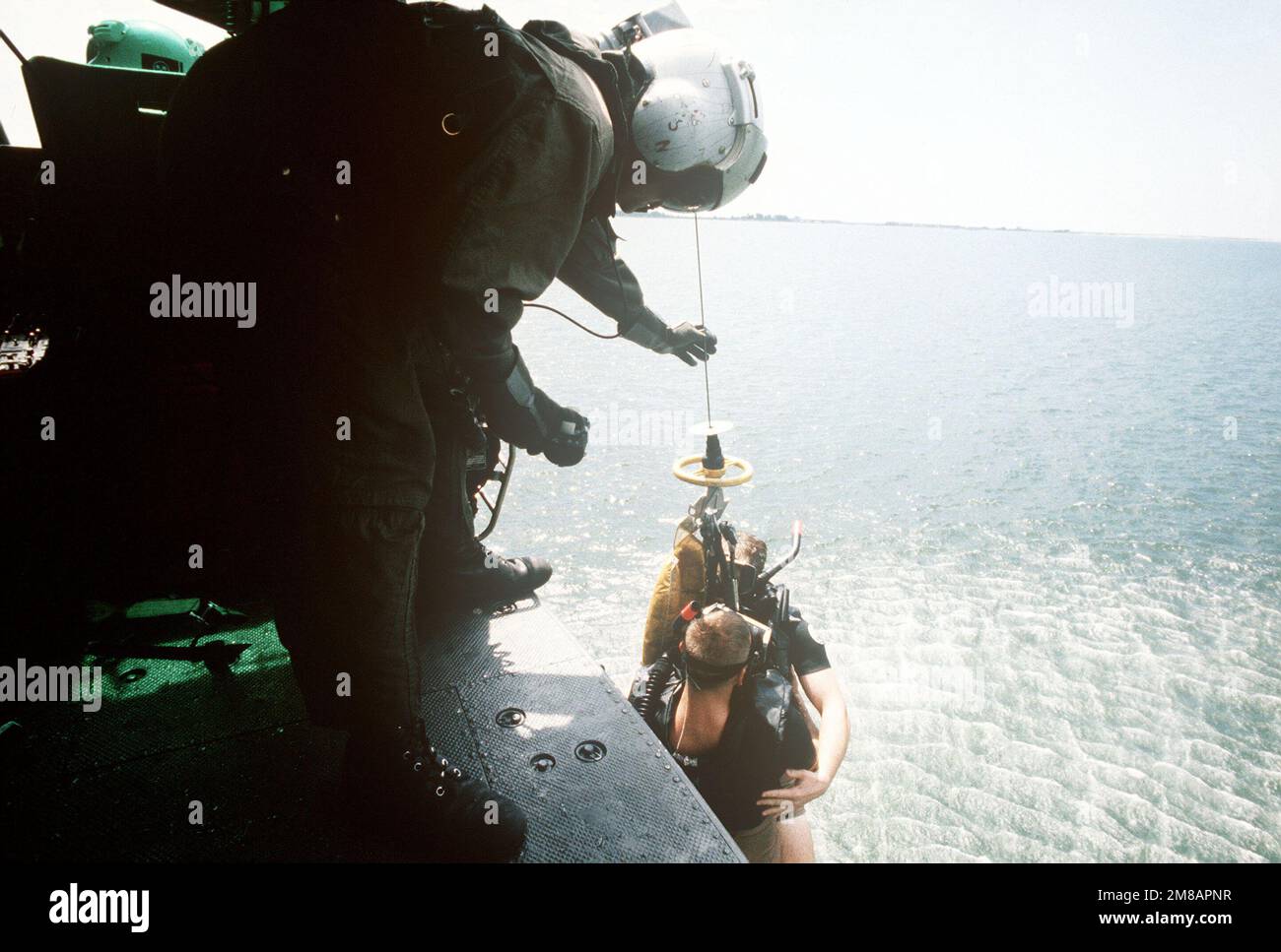 The crew chief aboard a Helicopter Combat Support Squadron 16 (HC-16 ...