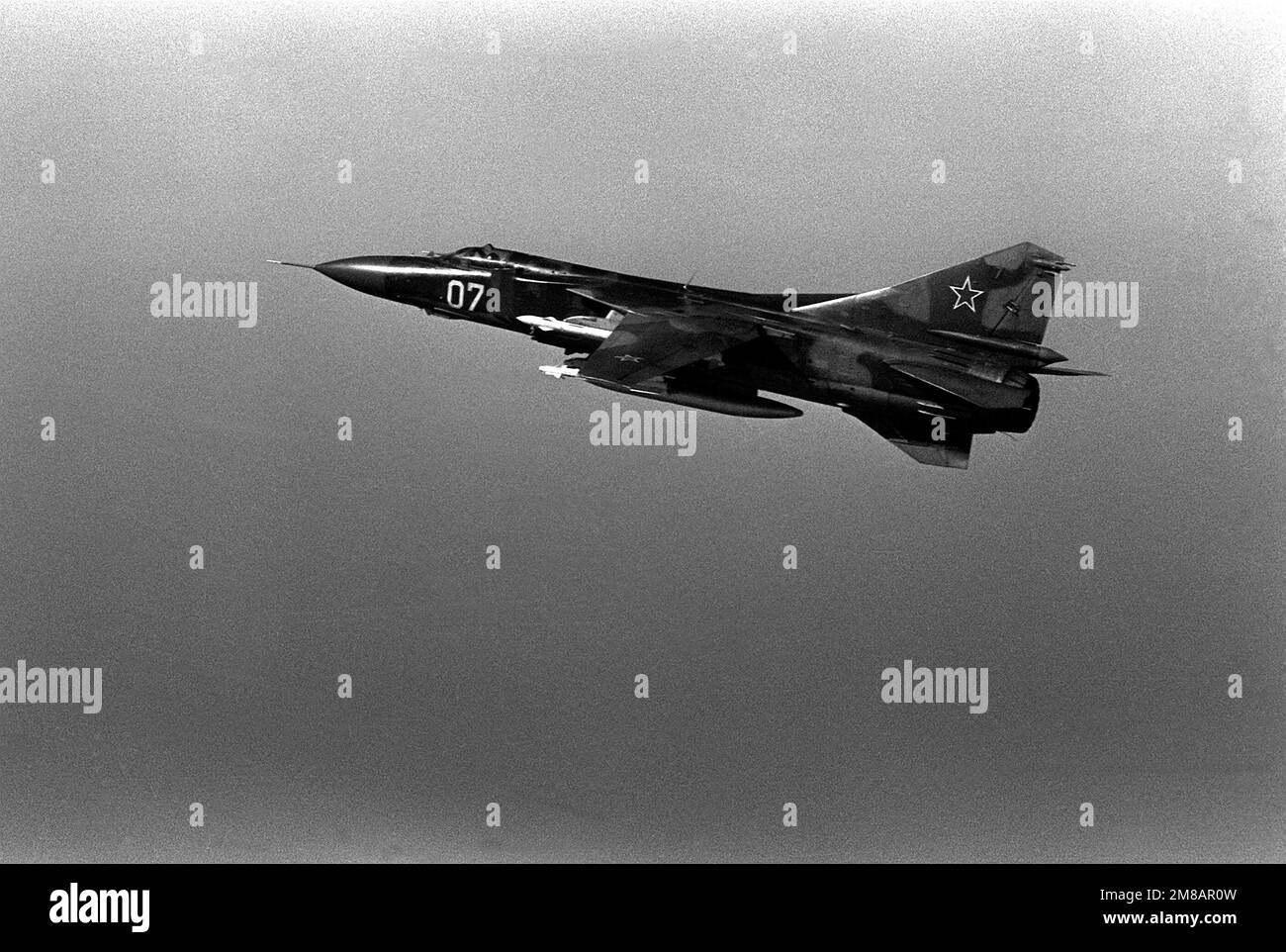An air-to-air left side view of a Soviet MiG-23 Flogger aircraft ...