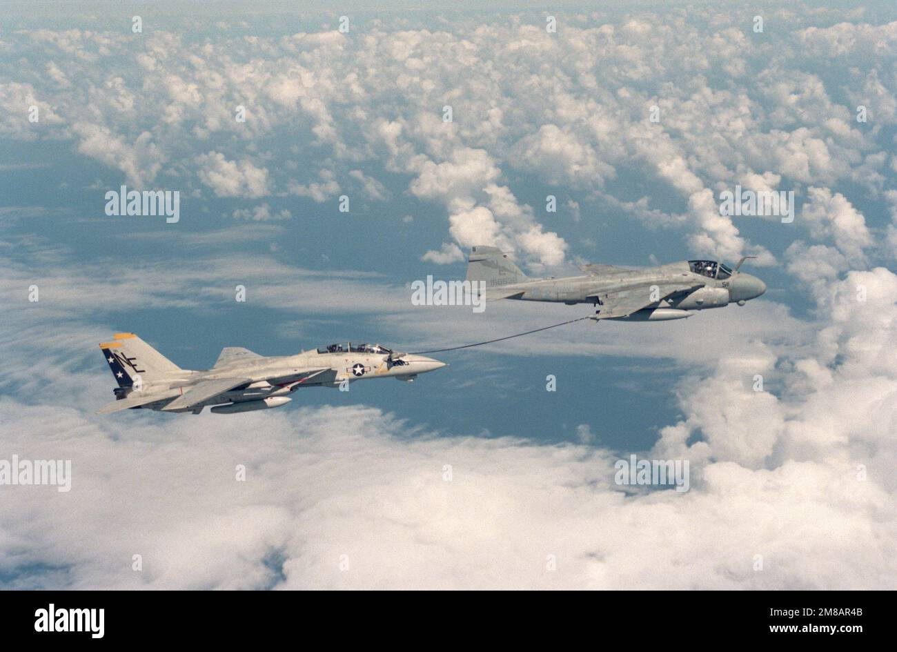A Fighter Squadron 2 (VF-2) F-14A Tomcat aircraft takes on fuel from an ...