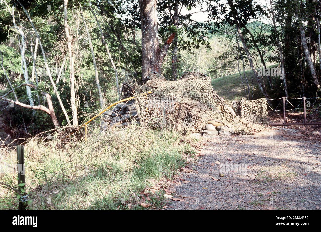 A sandbagged and camouflaged position stands at the entrance to a ...