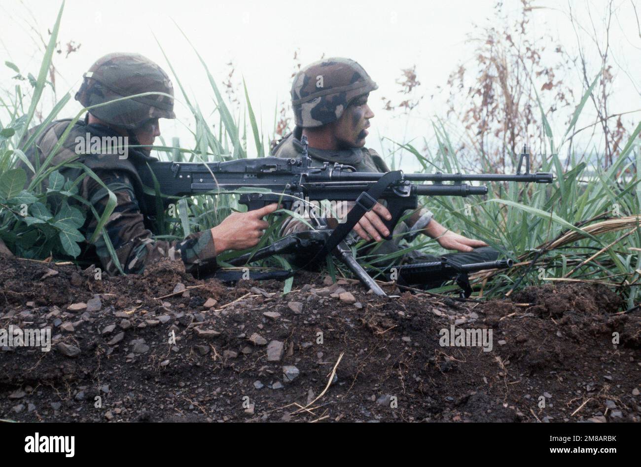 A Marine gunner and assistant gunner man their M60 machine gun during a ...