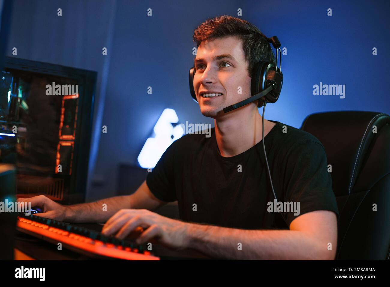 Young Caucasian handsome professional cybersport player training or ...