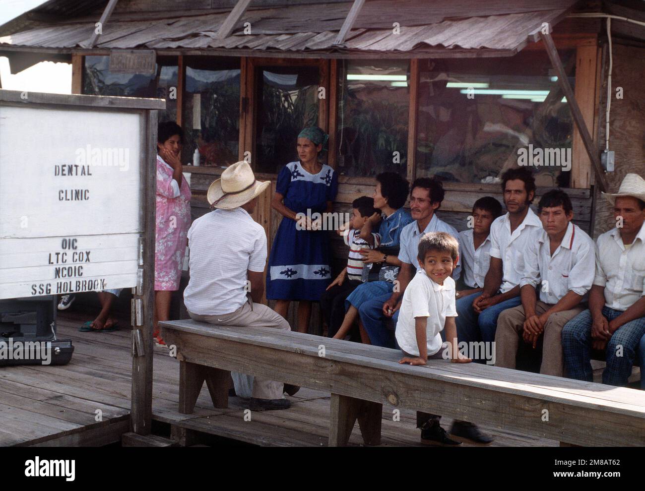 Hondurans wait outside of the U.S.-run detail clinic. Base: Soto Cano ...