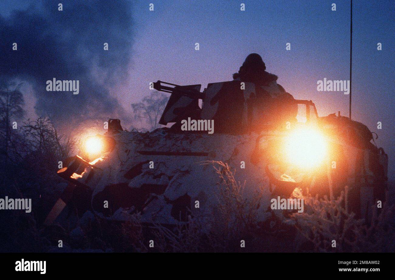 A soldier mans the M-2 .50 caliber machine gun atop an M-113 armored ...