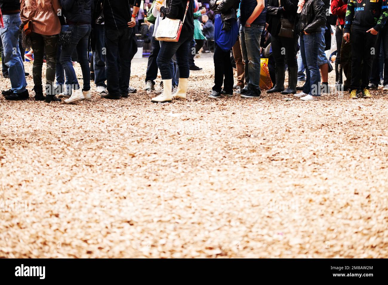 Waiting for the show to begin. the legs of a large crowd of festival ...
