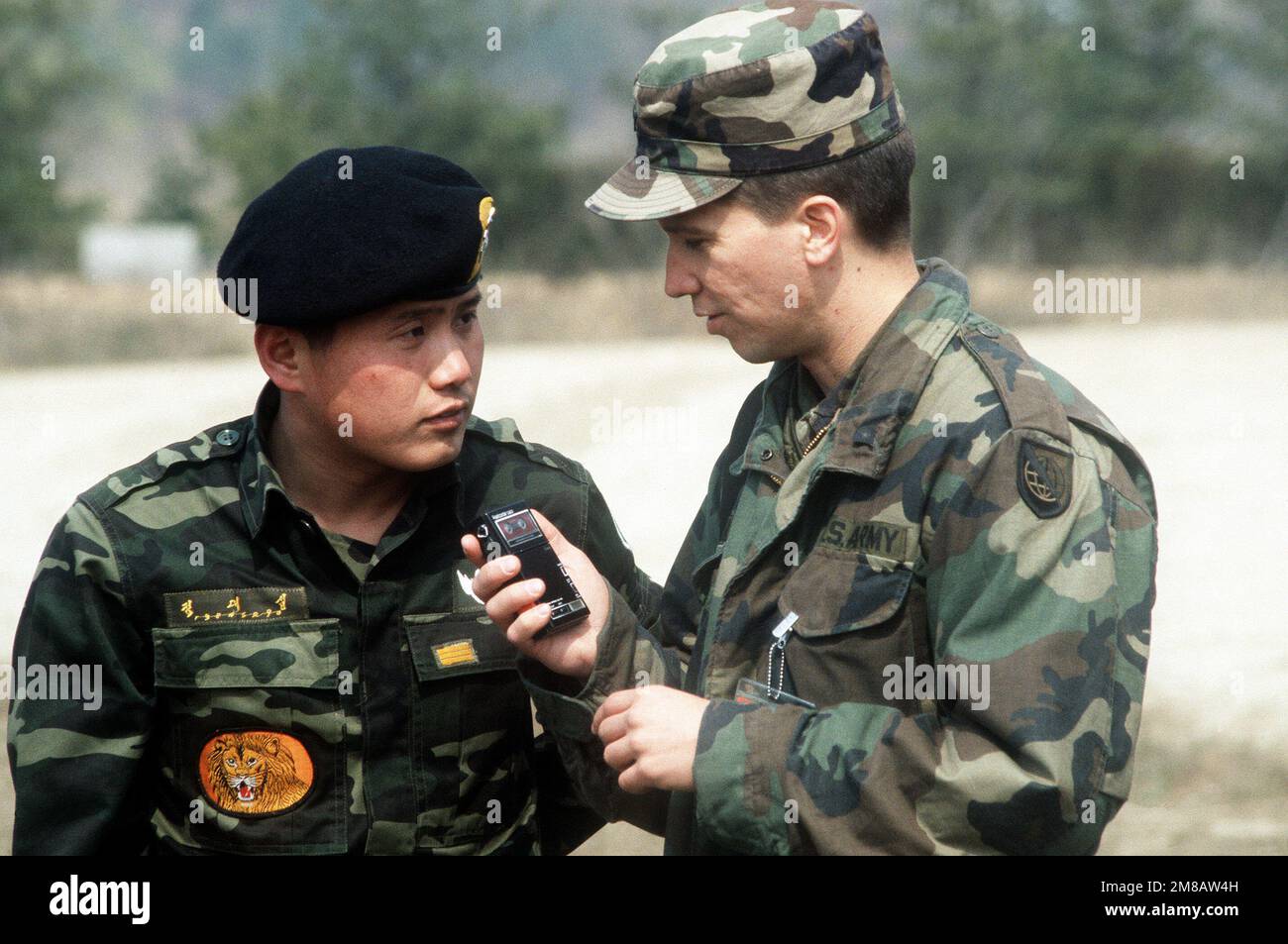 A South Korean soldier and an American soldier converse after a ...