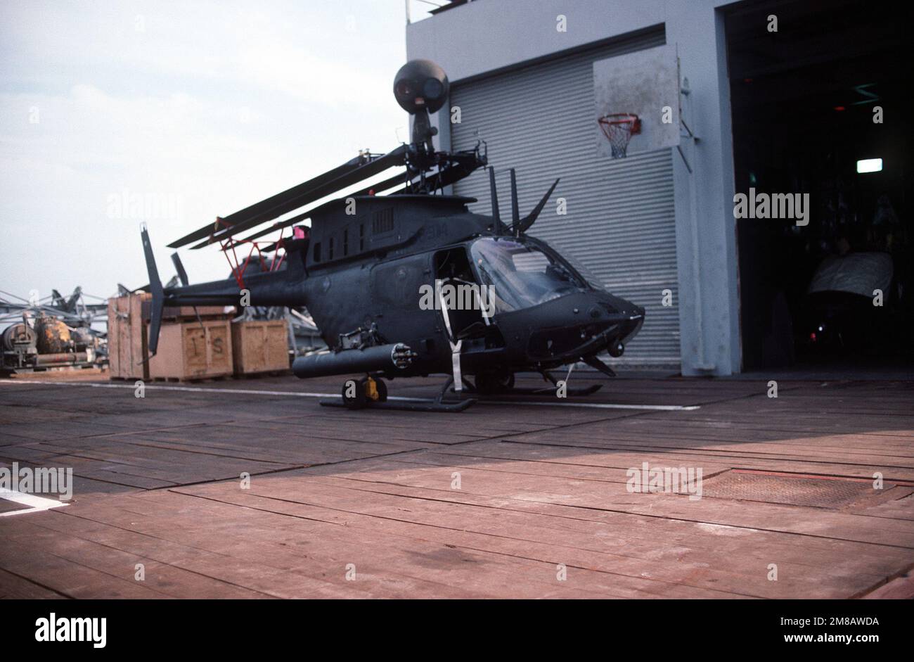 A front right view of a modified OH-58 Kiowa helicopter on the deck of ...