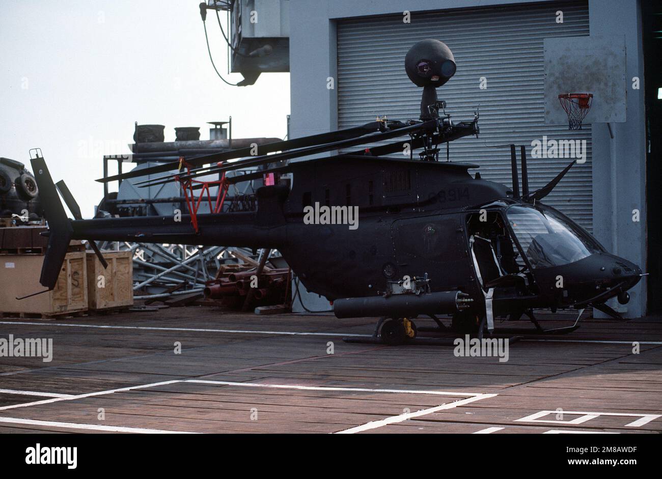 A right side view of a modified OH-58 Kiowa helicopter on the deck of ...