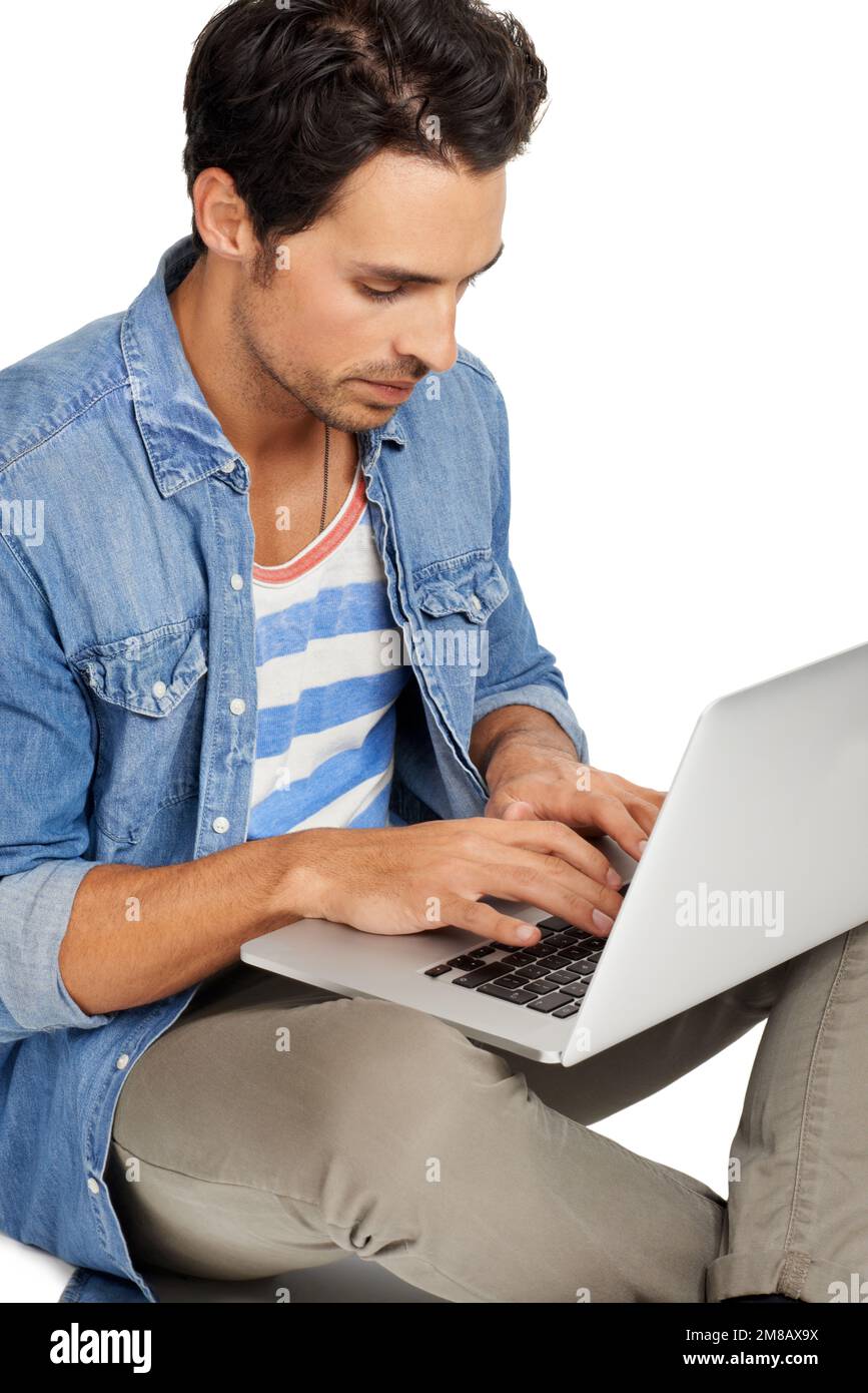 Getting the most out of technology. A handsome young man working on his ...