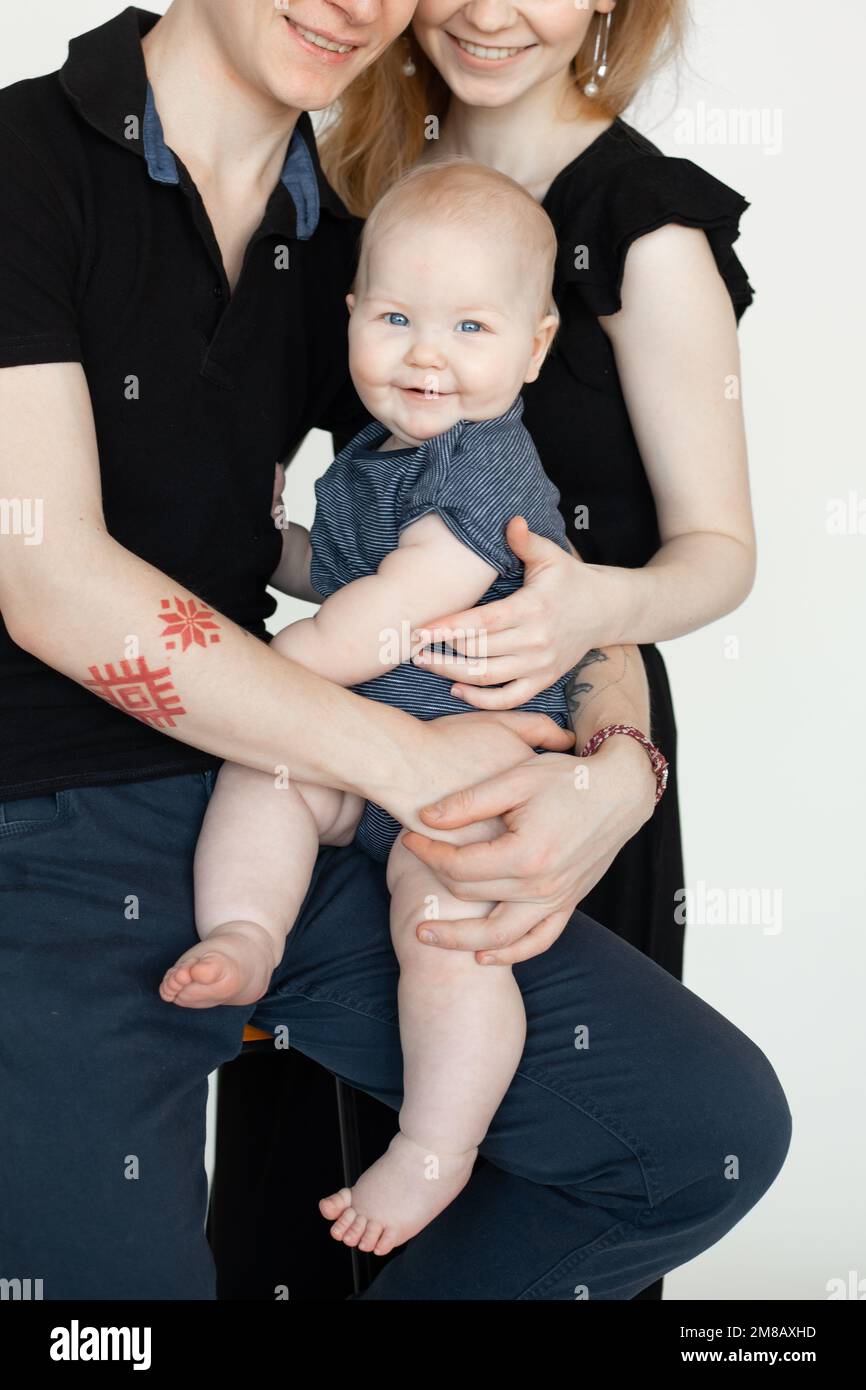 Young family from three in black looks on white background. Happy ...
