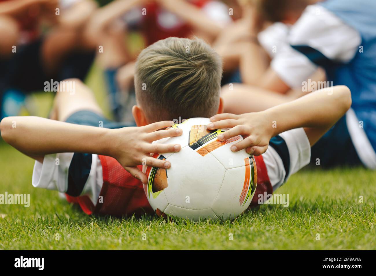Boy soccer ball under his head hi-res stock photography and images - Alamy