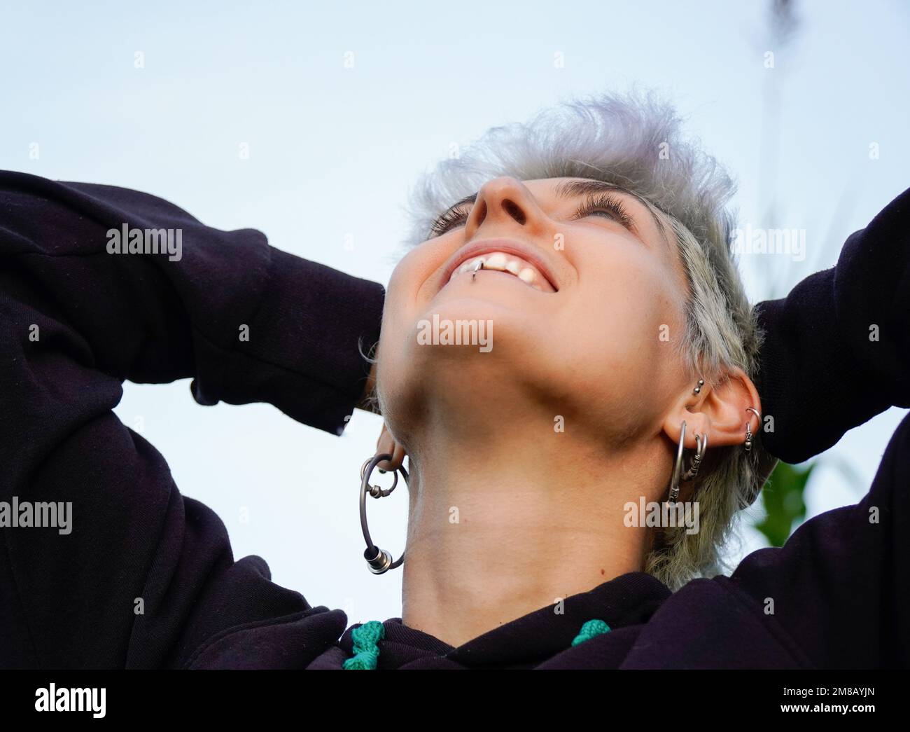 portrait of non-binary person looking up. emotional well-being Stock ...