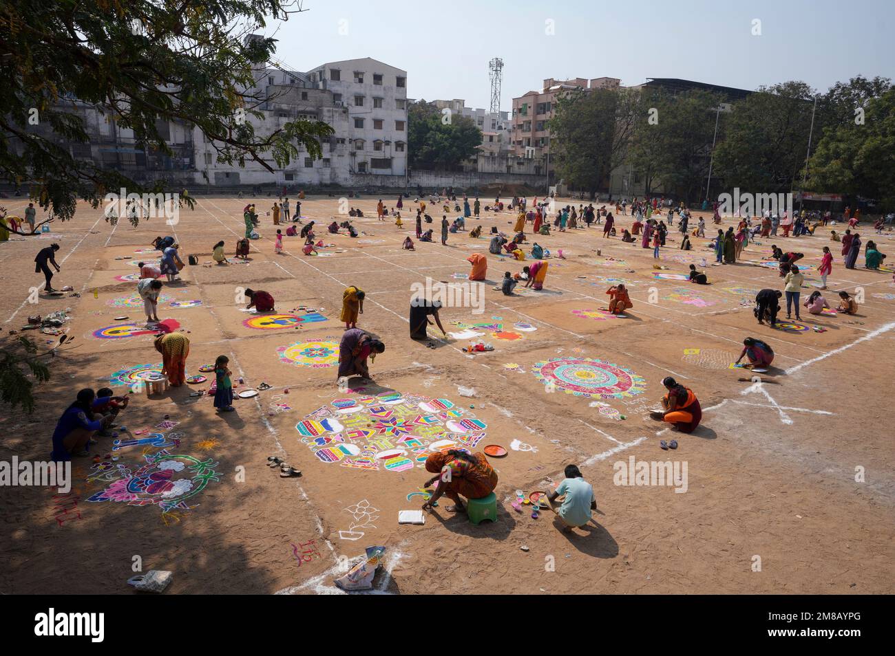People prepare a Rangoli, a traditional art work of colored powder ...