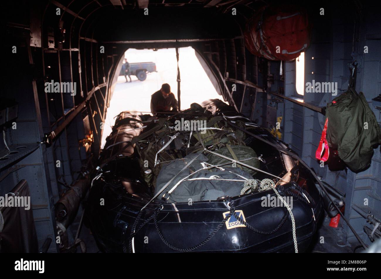 An Army Special Forces Zodiac raft is loaded into an MH-53J Pave Low ...
