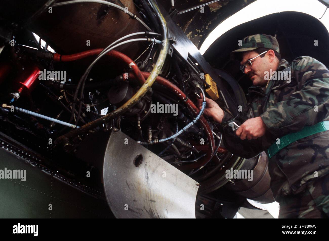 A technician works on an aircraft engine during Jaguar Bite '89, a ...