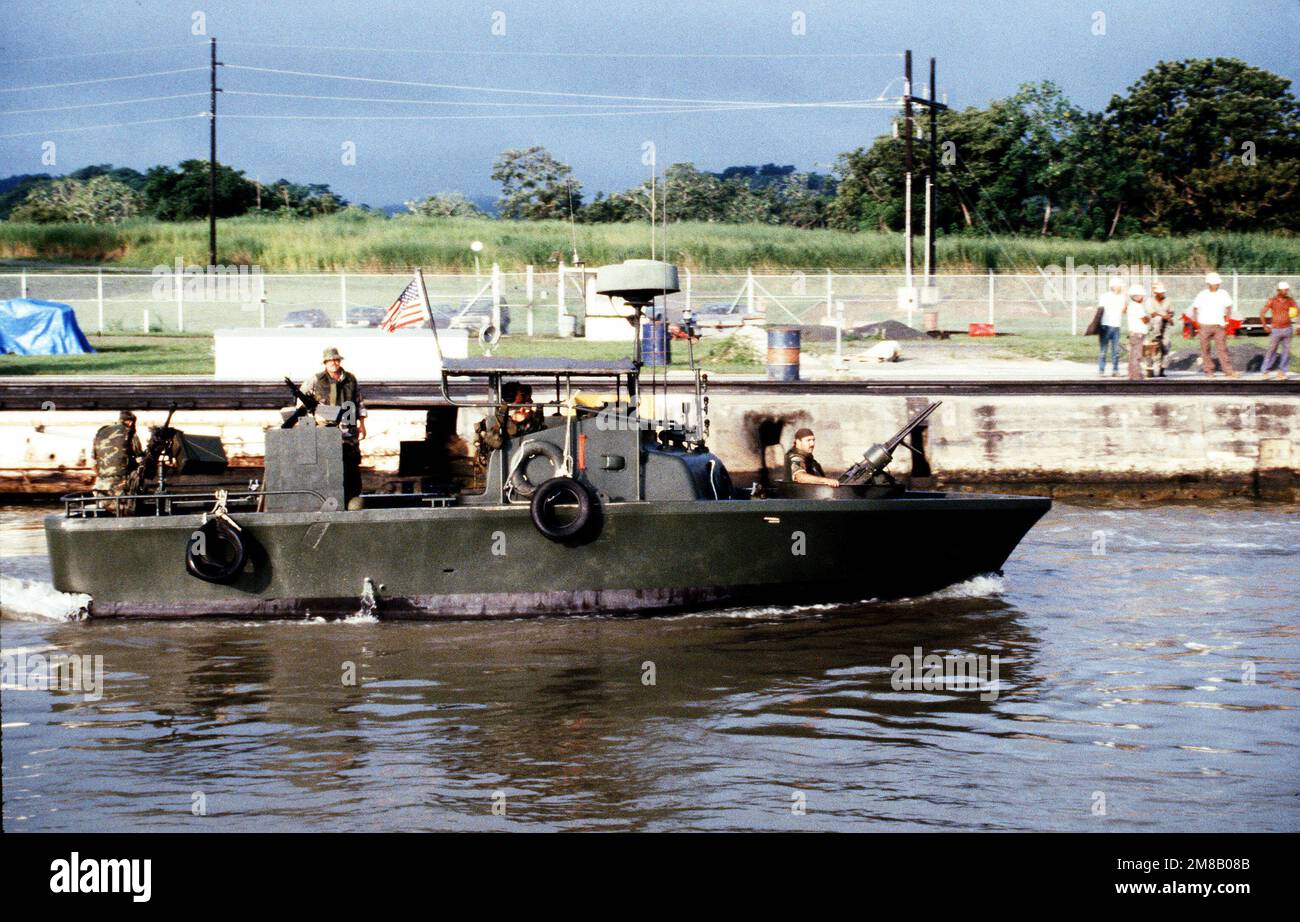 Crewmen aboard a US Navy PBR Mark 2 river patrol boat keep watch as ...