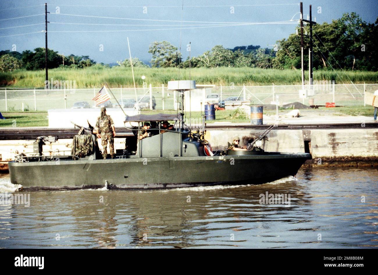 Crewmen aboard a US Navy PBR Mark 2 river patrol boat keep watch as ...