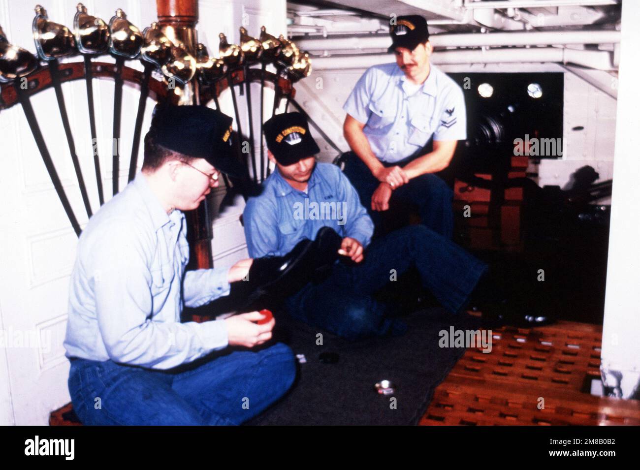 SEAMAN Christopher King and AIRMAN Leo Capelette shine their shoes as ...