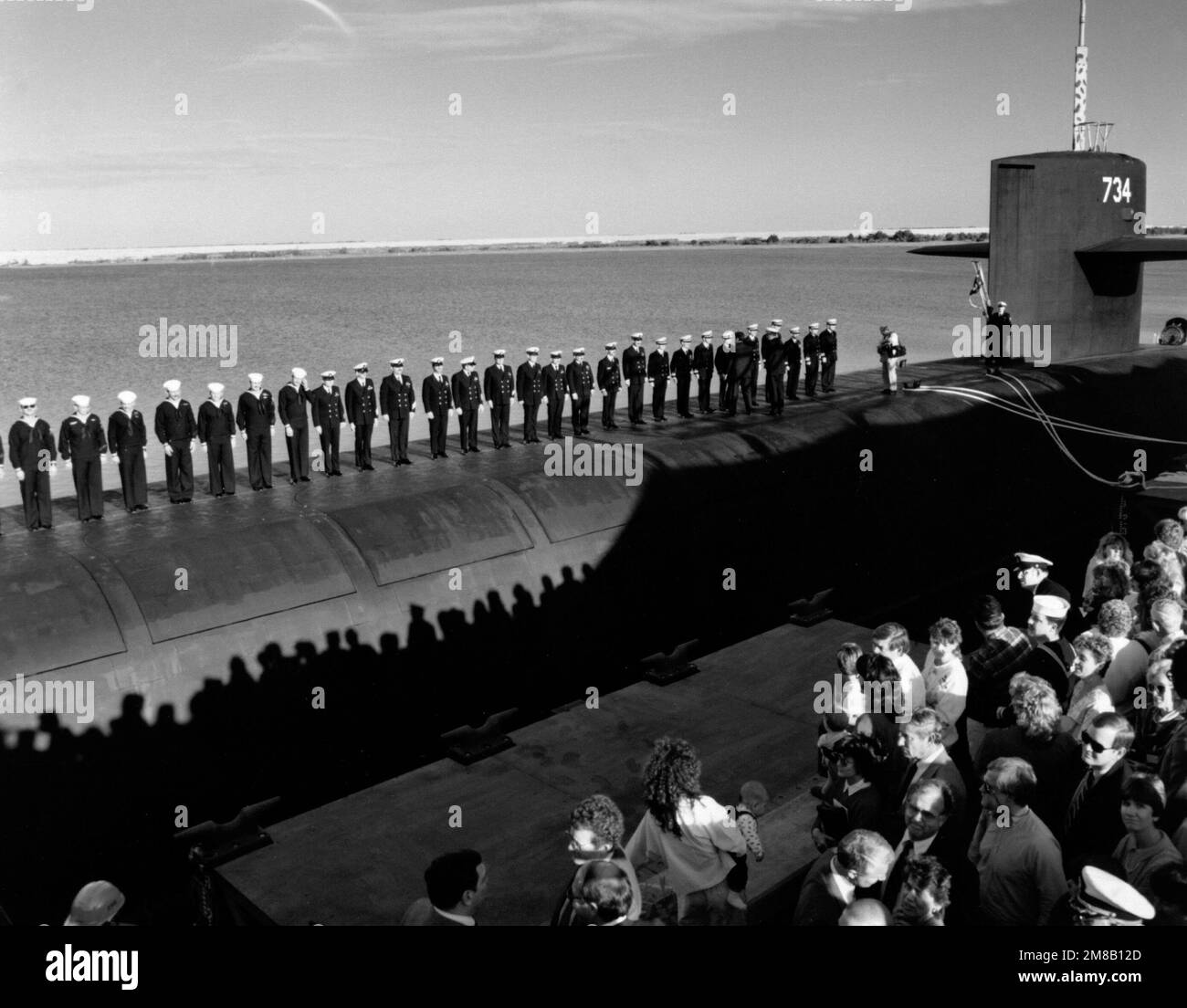 Crewmen stand in formation for inspection on the deck of the nuclear ...