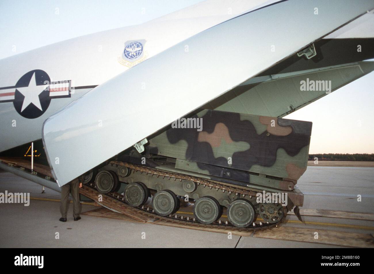 A multiple launch rocket system (MLRS) is winched onto a C-141B ...
