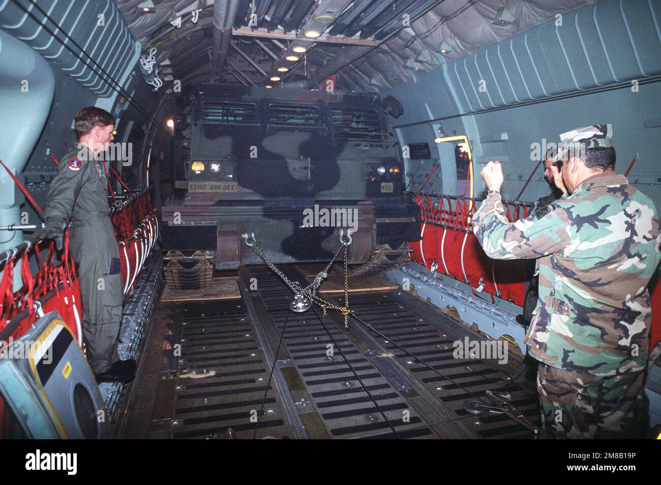 STAFF Sergeant Johnny Maldonado directs the winching of an M-270 ...