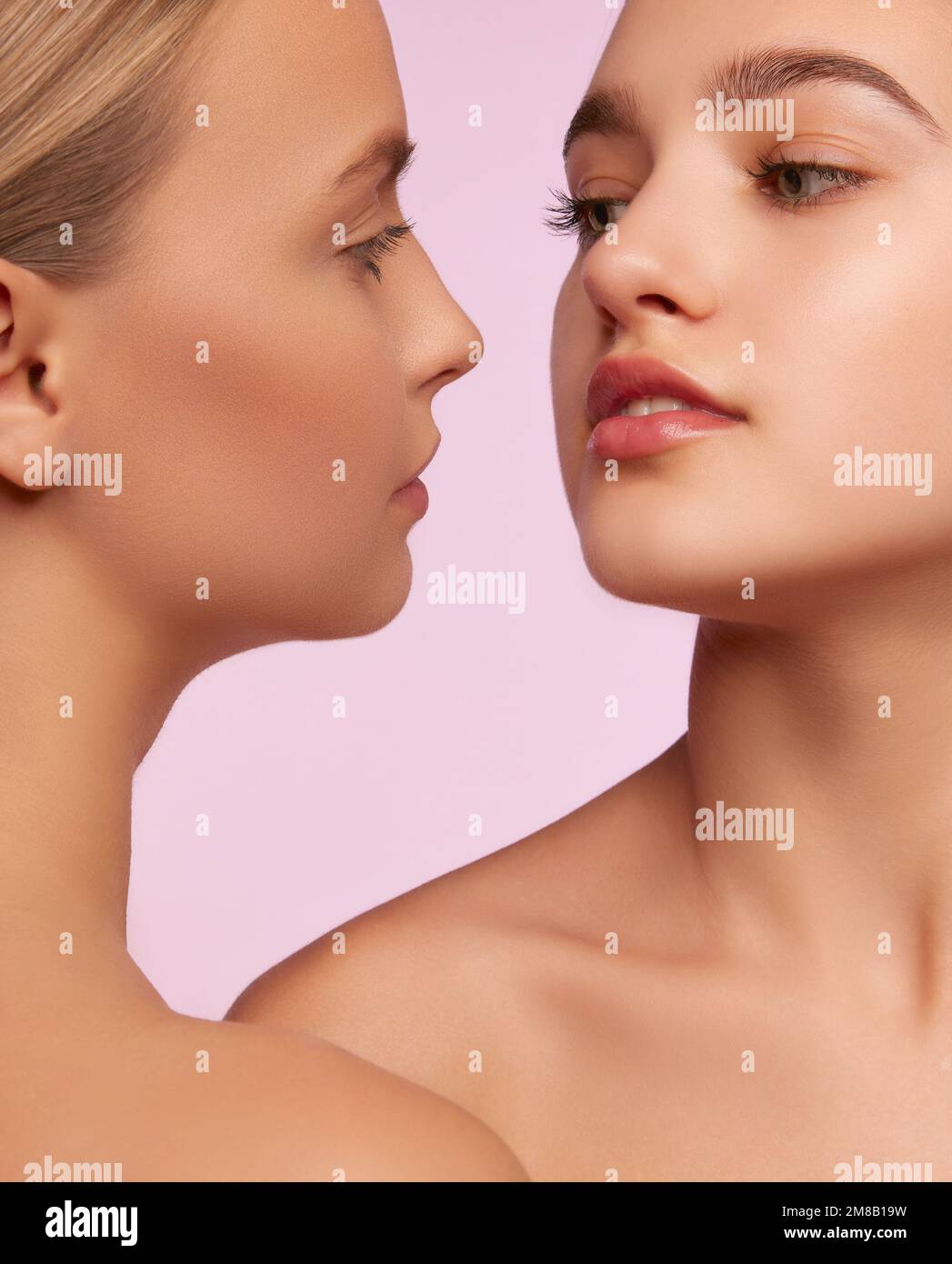 Beauty procedure face care. Portrait of two young, beautiful girls with ...