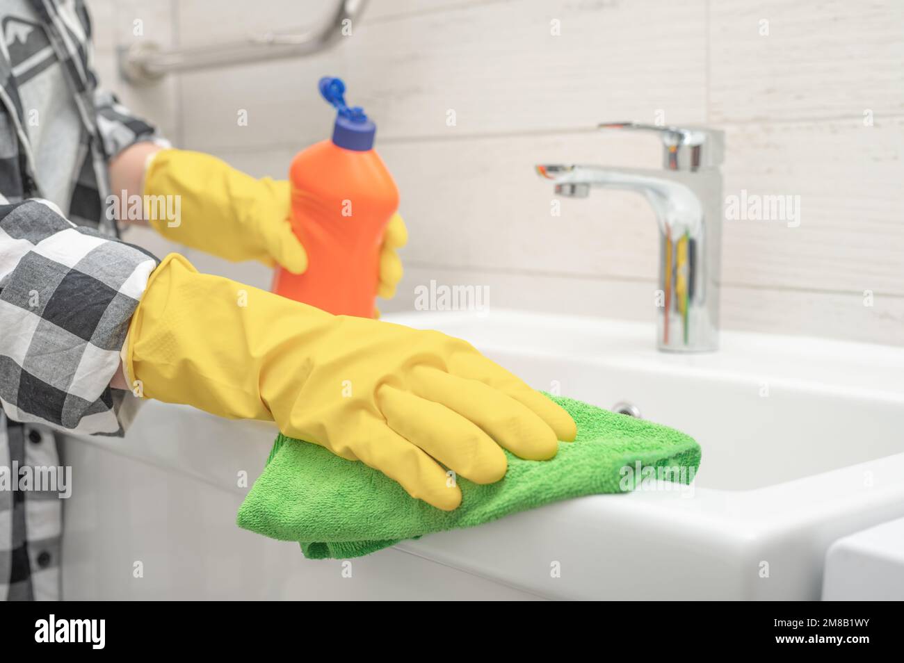 Man doing chores cleaning bathroom at home. Cropped view of woman in ...