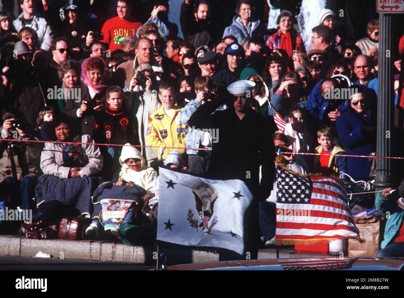A member of the cordon salutes as the presidential limousine passes his ...