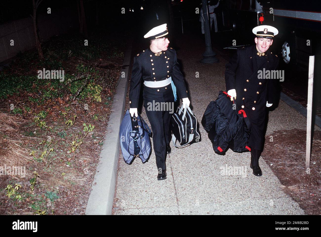 U.S. Navy midshipmen prepare to board buses after participating in the ...