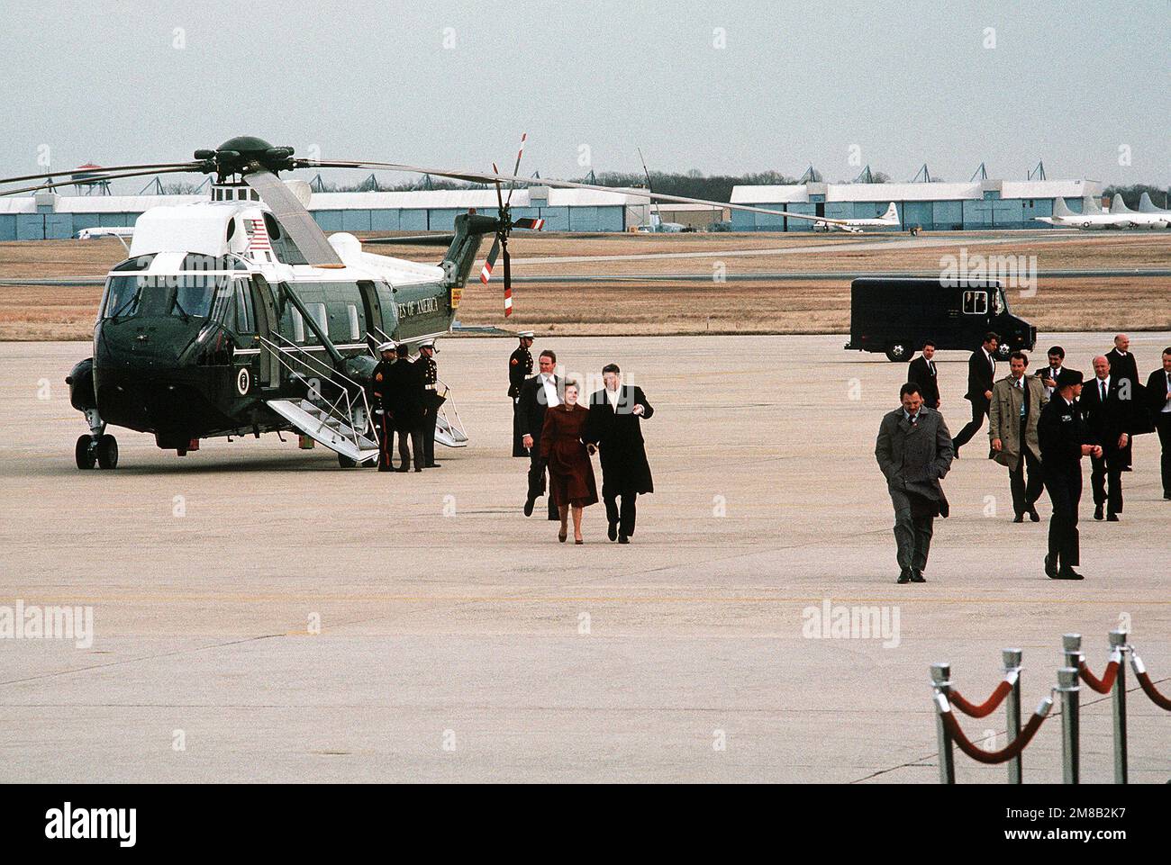 Former President Ronald W. Reagan and his wife, Nancy, walk from Marine One, a Marine ...