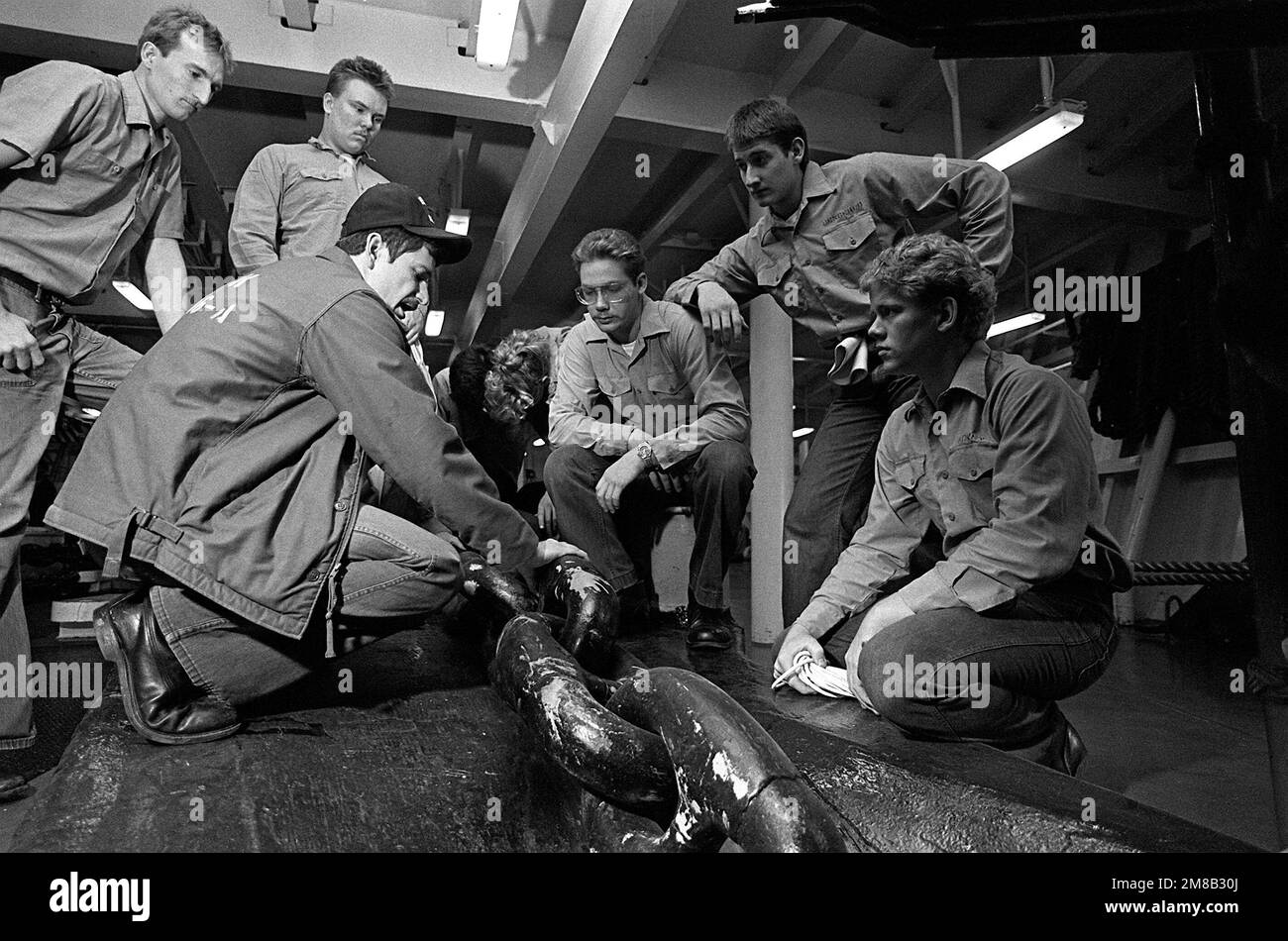 A crewmen from the destroyer tender USS ACADIA (AD-42) checks the ...