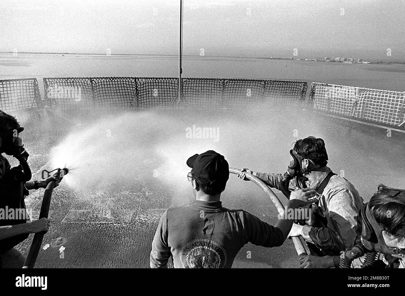 A crewman directs U.S. Navy reservists and Navy League Sea Cadets ...