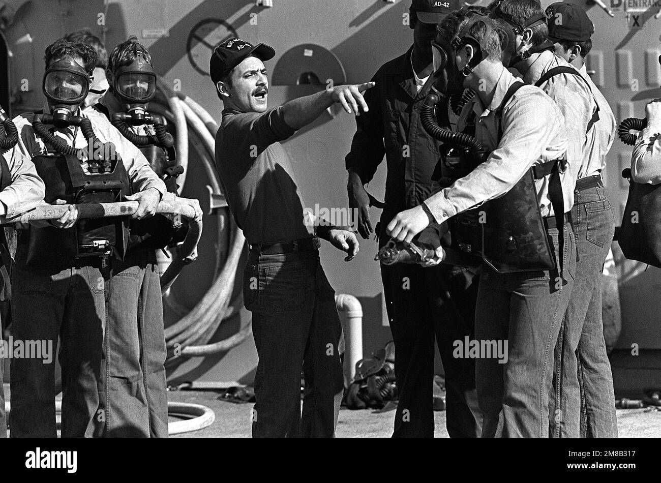 A crewman directs U.S. Navy reservists and Navy League Sea Cadets ...
