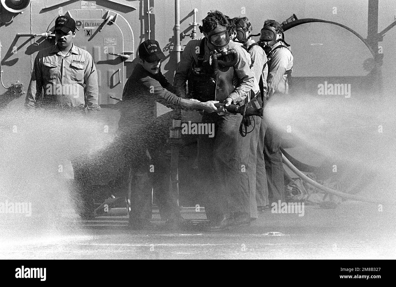 Crewmen from the destroyer tender USS ACADIA (AD-42) assist Navy ...