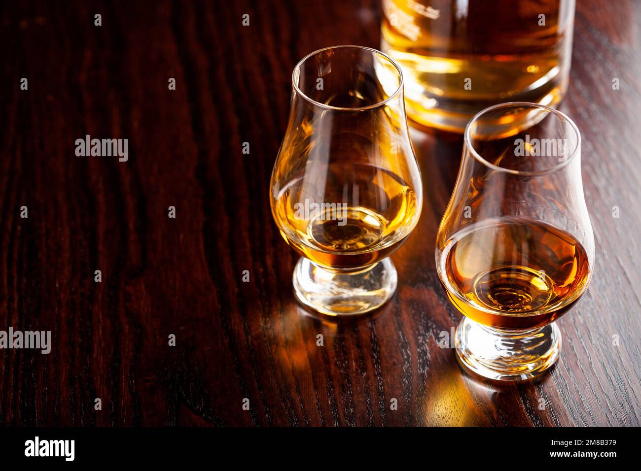 glass of whisky spirit brandy on dark brown background Stock Photo - Alamy